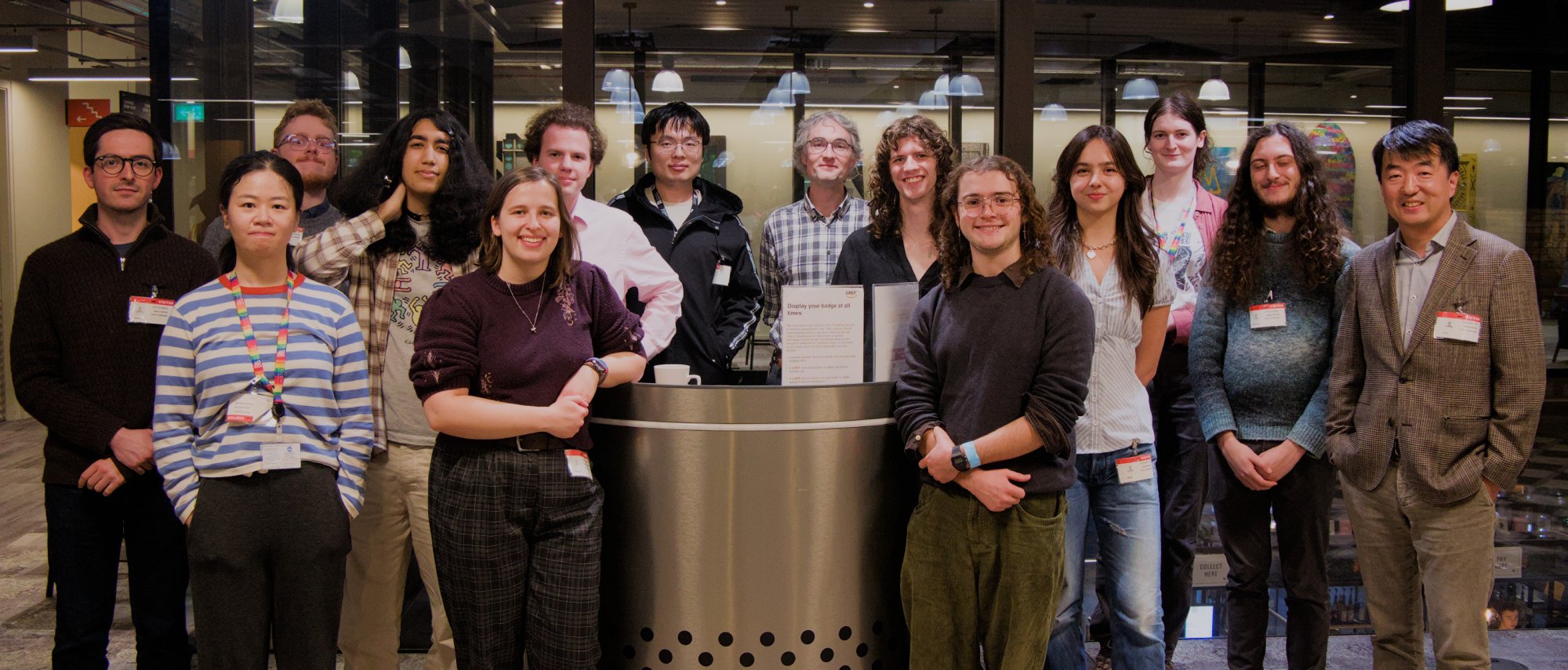 14 of us, PLRG members and undergrads, posing for a group photo at AWS headquarters in London ...