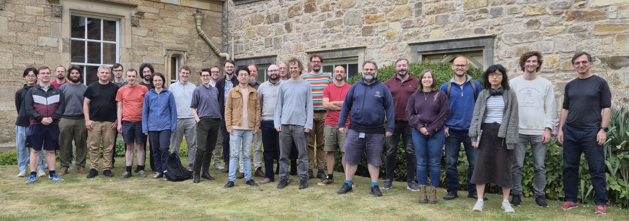 Sam with a large group of friendly people at the EHOP workshop 2025